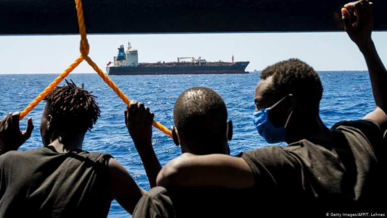 Desperate migrants jump overboard from stranded tanker in Mediterranean ...